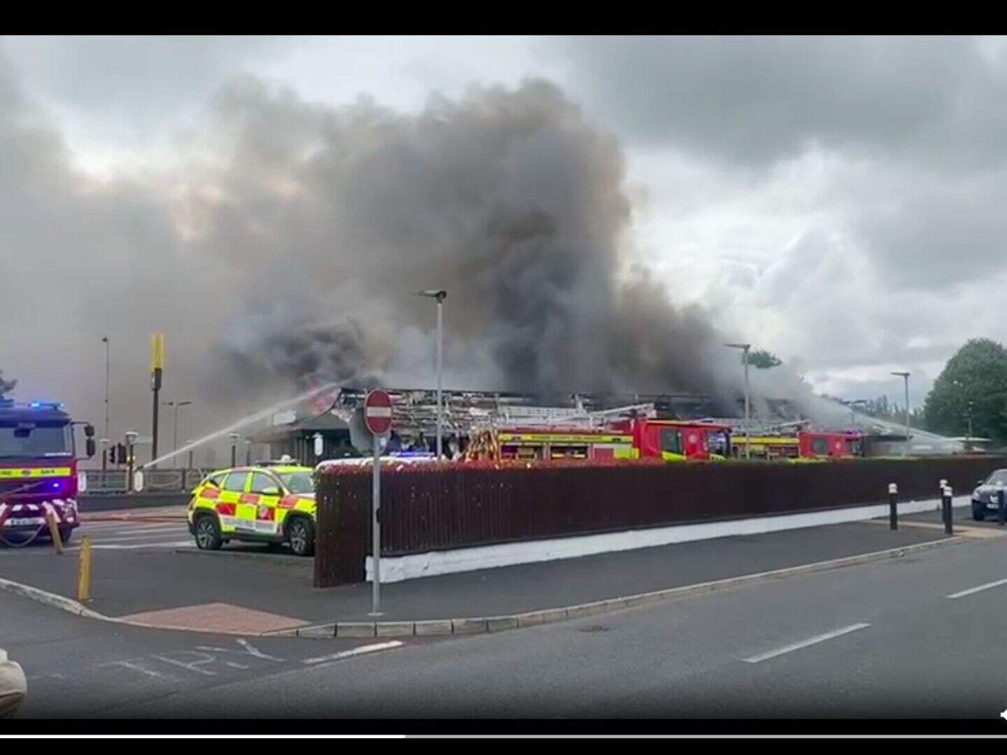 Fire crews battle massive fire at McDonalds after car bursts into ...